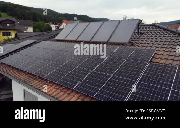 Drone View of Solar and Water Panels on a Tiled Roof of a Residential ...