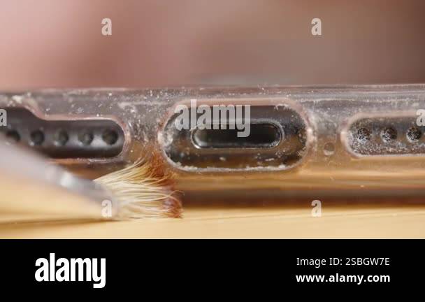 Smartphone charging port and speaker holes shown in extreme close-up ...