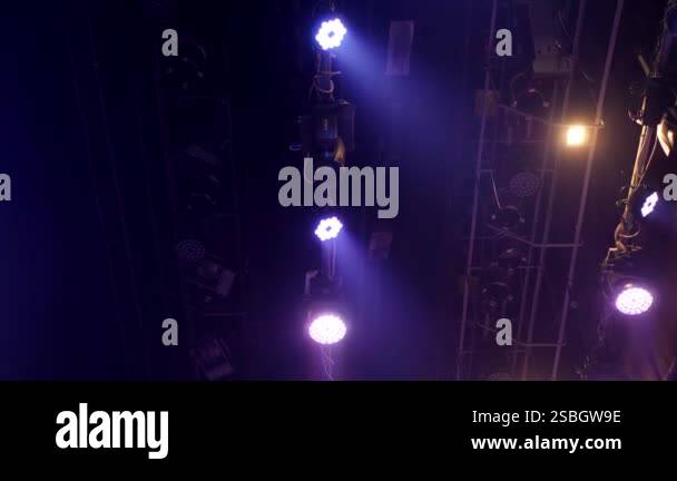A constellation of stage lights, casting vibrant beams across the ...