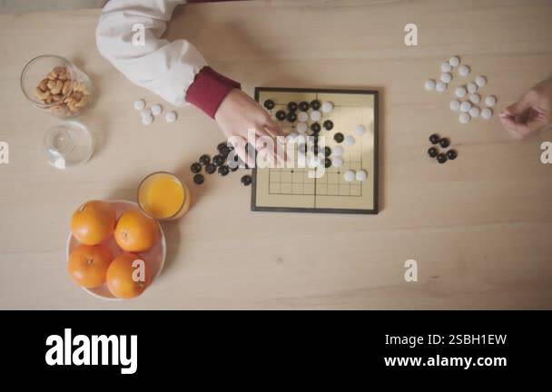 Close-up and top-view shots of Go, oriental checkers board game on ...