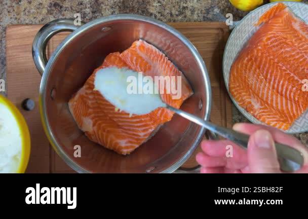 The process of salting salmon fish. The pieces of fish sprinkled with ...