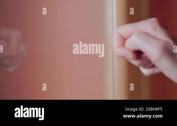 Female hand knocking on glass door , visitor or guest is at the door ...