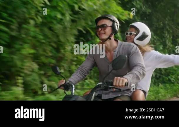 Happy couple ride on motorbike. Two lovers travel by motorcycle in ...