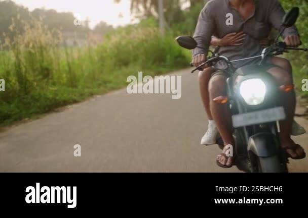 Happy man, woman ride on motocycle. Young family travel by motorbike in ...