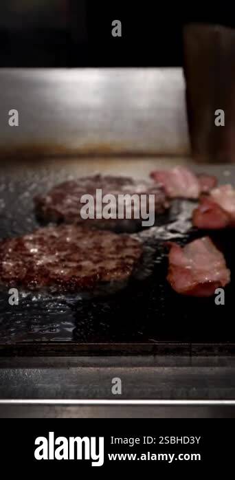 Juicy beef patties and crispy bacon sizzle on the grill, creating the ...