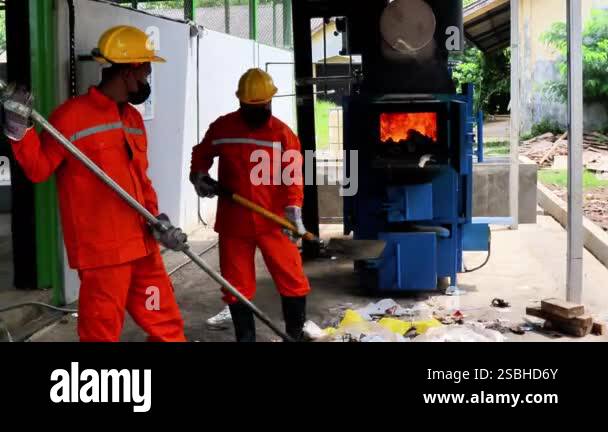 Portrait of workers wearing safety suits and helmets, while working at ...