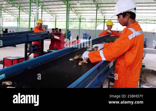 Portrait of workers wearing safety suits and helmets, while working at ...