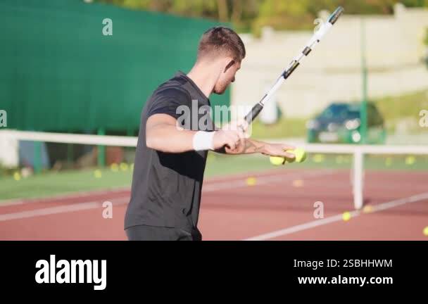 Man practice tennis ball shots on court. Tennis player shots balls ...