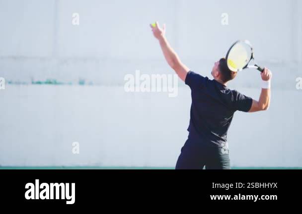 tennis workout of man on open court, back view of athletic man striking ...