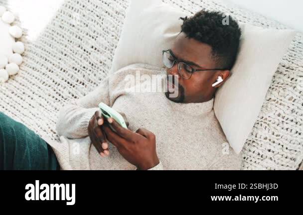 Sleepy exhausted man lazy typing message in smartphone. African ...