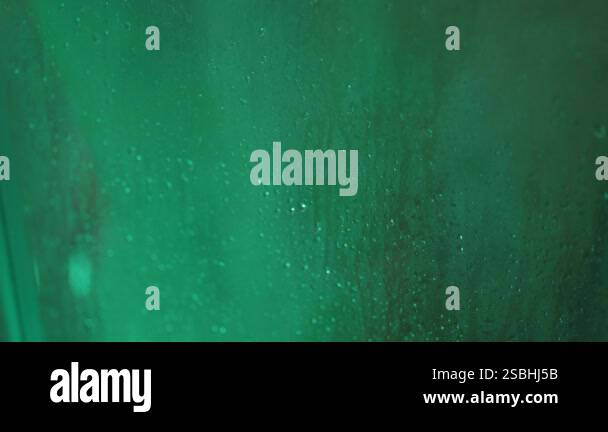 Misted glass with water drops in shower. Man taking shower, view ...