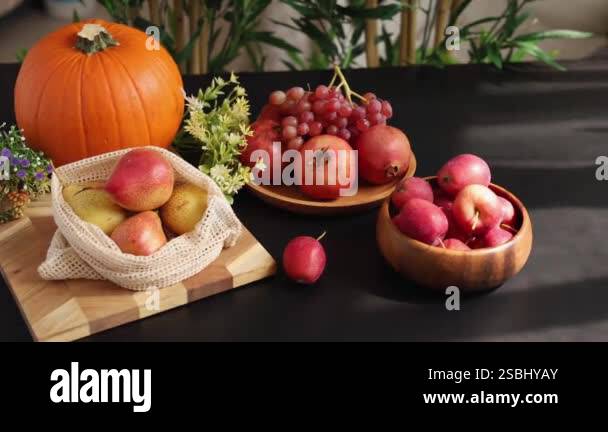 Mixed fruits including orange pumpkin, red pomegranates, and pink ...