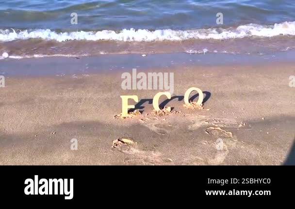 Eco letters on sandy shore promote environmental awareness, eco message ...