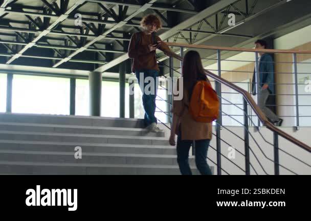 Four school Caucasian students meeting morning indoors in corridor ...