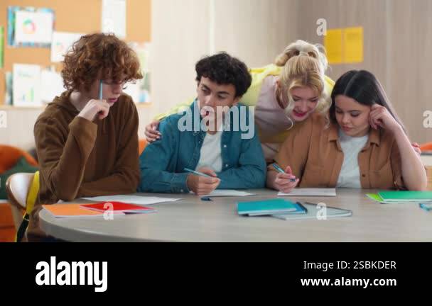 Four school Caucasian students pupils studying indoors male female ...
