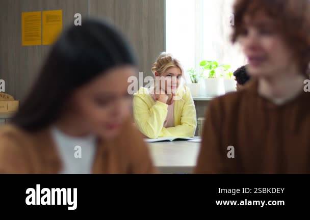 Four school mates students pupils studying in class lesson blurry man ...