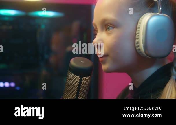 Closeup talking microphone chattinglittle girl child kid daughter ...