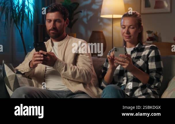 Gadgets addicted couple Caucasian man woman family using smartphones on ...