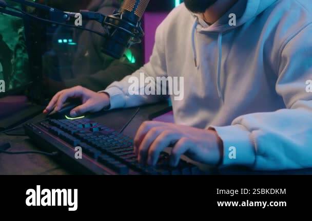 Millennial man male guy gamer evening home neon room playing video game ...