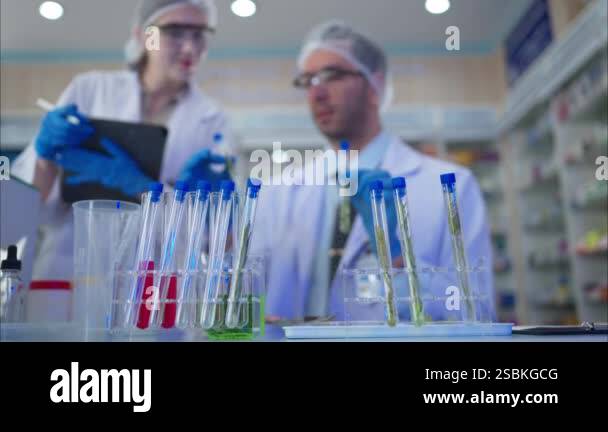 Pharmacist and chemical scientist doing antibiotic trials and testing ...