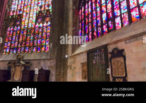 The vertical panorama of colored stained-glass windows of the apse of ...