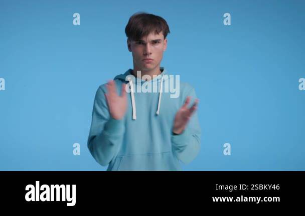 angry and frustrated casual man clapping his hands while having a scowl ...