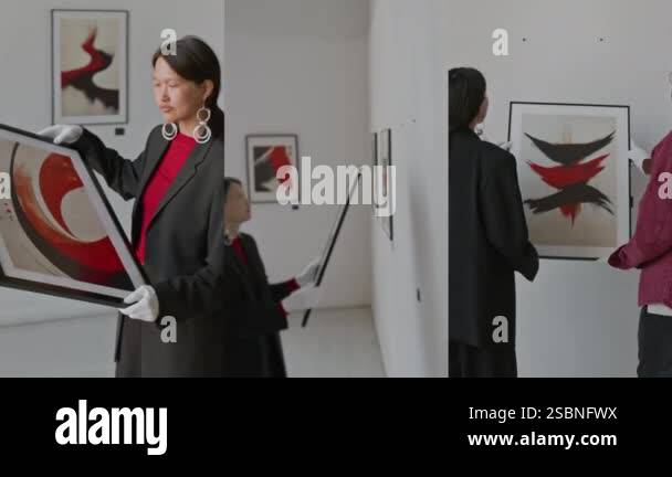 Split Screen of Asian art curator inspecting abstract paintings and ...