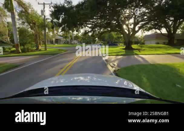 Car point of view. Vehicle driving on suburban street between ...