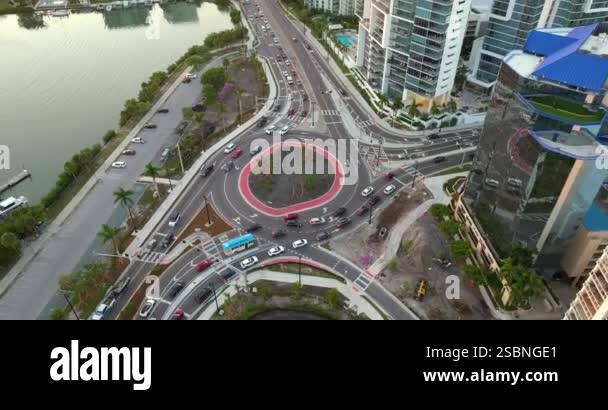 Sarasota, Florida city street traffic on Gulfstream Avenue roundabout intersection with moving ...