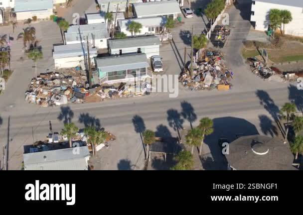 Heaps of debris rubbish on street side near severely damaged by ...
