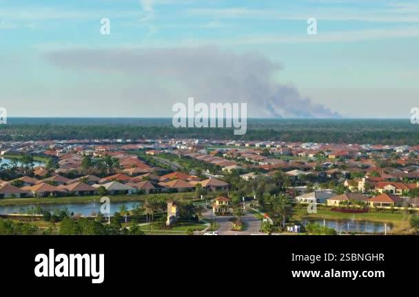 Prescribed fire smoke rising up over suburban neighborhood in Florida ...