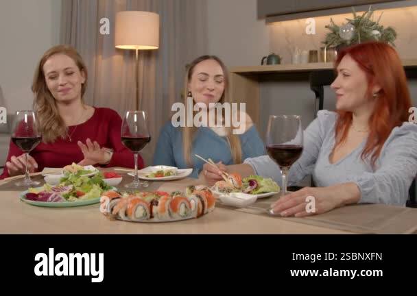 Positive attractive female friends enjoying leisure , having tasty ...