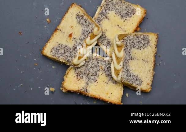 sponge cake with poppy seed filling on black background Stock Video ...