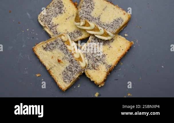 sponge cake with poppy seed filling on black background Stock Video ...