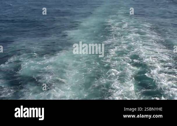Rippling, foamy wake trailing behind a ship, showcasing vibrant ...