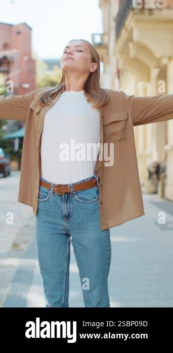 Caucasian young woman taking a deep breath of fresh air, relaxing ...