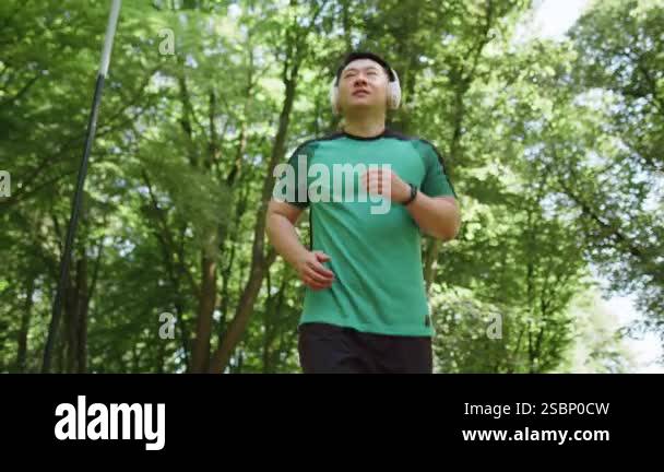 Athletic fitness sport runner man training marathon run, listening ...