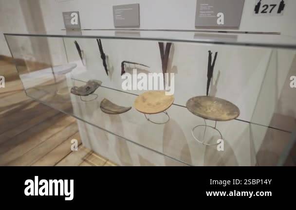 Ancient kitchen utensils along with tools presented in transparent ...