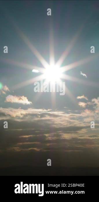 Vertical video - sun rays illuminate the sky and clouds, casting sun ...