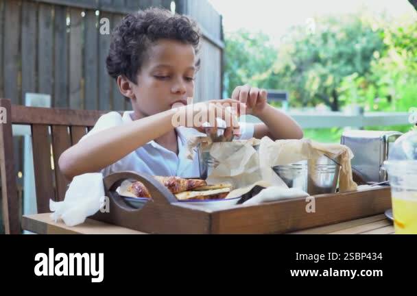 hungry african american teenager eats french fries with ketchup in park ...