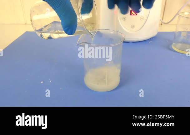 Macro shot of a cosmetic emulsion being prepared in a laboratory. The ...