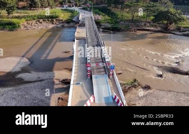Steel bridge structure over a partially damaged or flooded river with ...