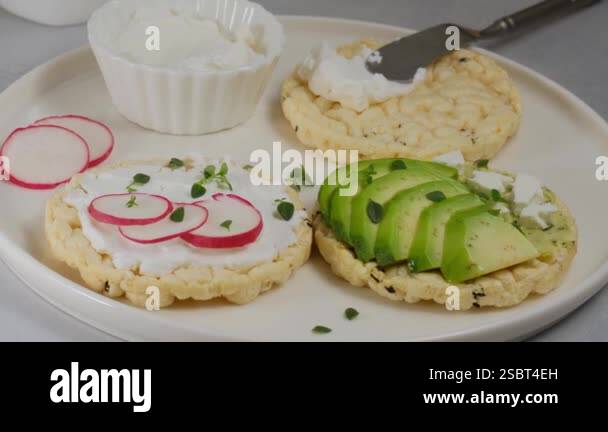 Crisp bread healthy snack with cream cheese, avocado, radish stripes ...