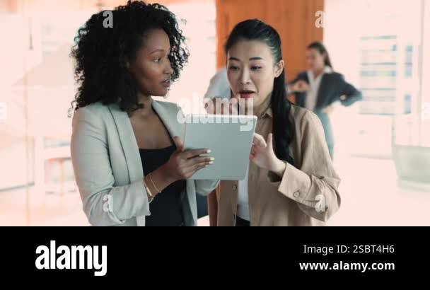 Young African American project manager woman showing tablet to Asian ...