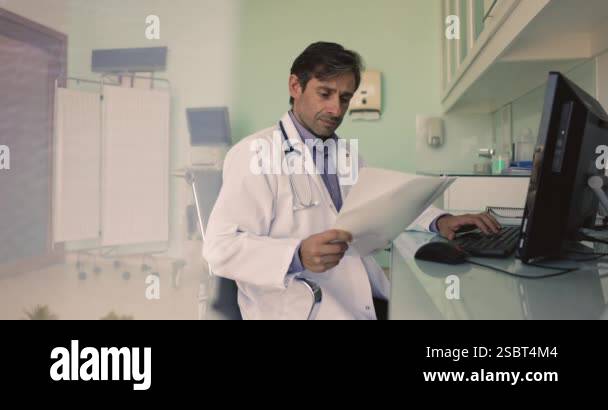 Focused experienced male doctor analyzing paper medical records ...