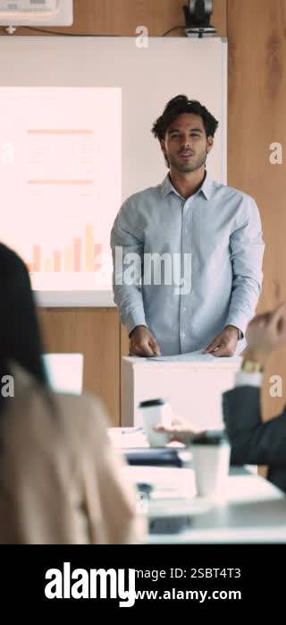 Confident business presenter man speaking to audience in conference ...