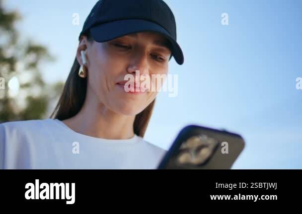 Stylish lady messaging smartphone outdoors closeup. Portrait smiling ...