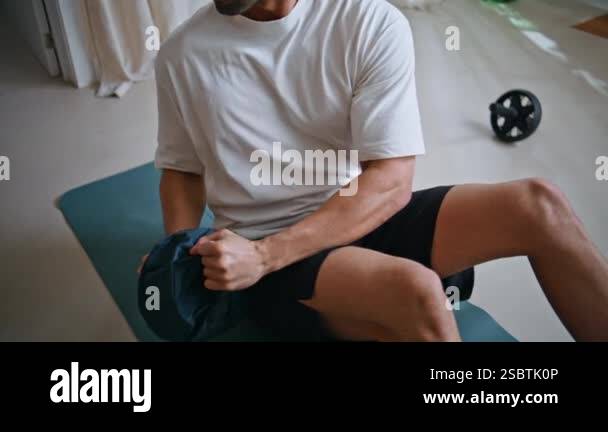 Closeup athlete holding weight practicing twisting exercises in gym ...