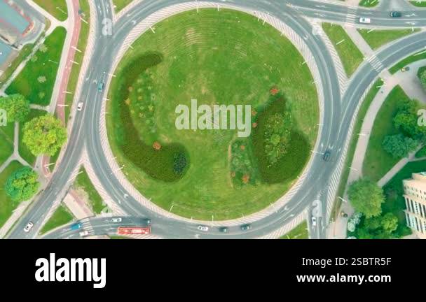 Aerial rotating top-down view of a roundabout or traffic circle ...