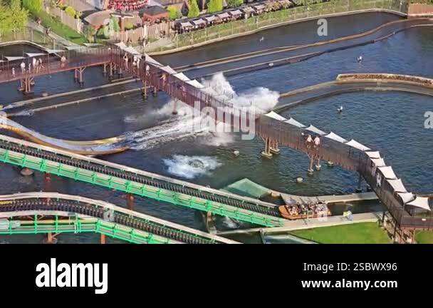 Aerial view of a water ride and pedestrian bridge in a theme park ...